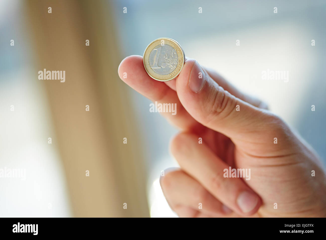 hand with euro coin Stock Photo - Alamy