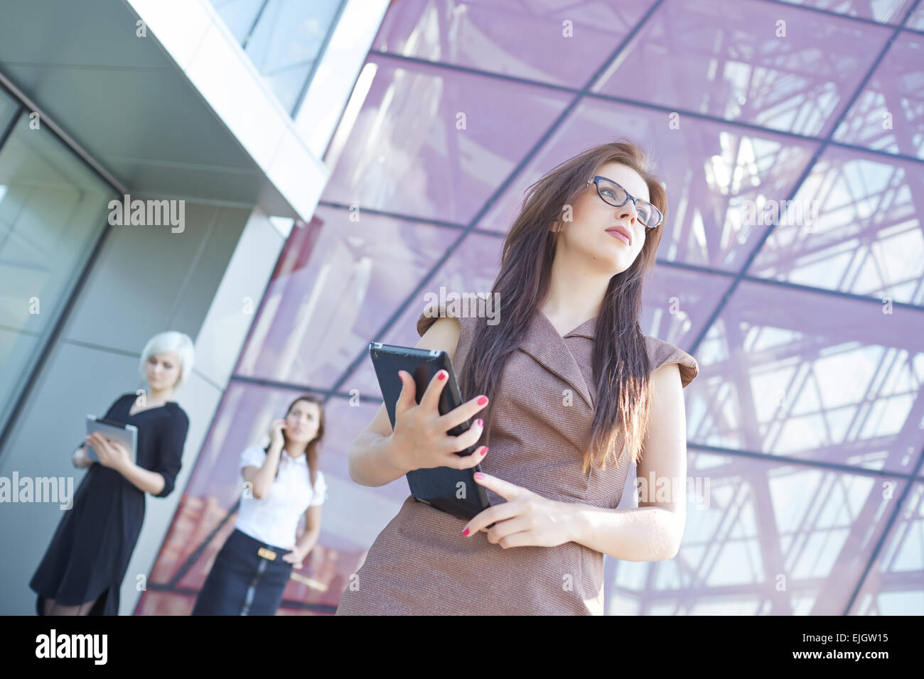 businesswomen whith tablets and phones on the street Stock Photo - Alamy