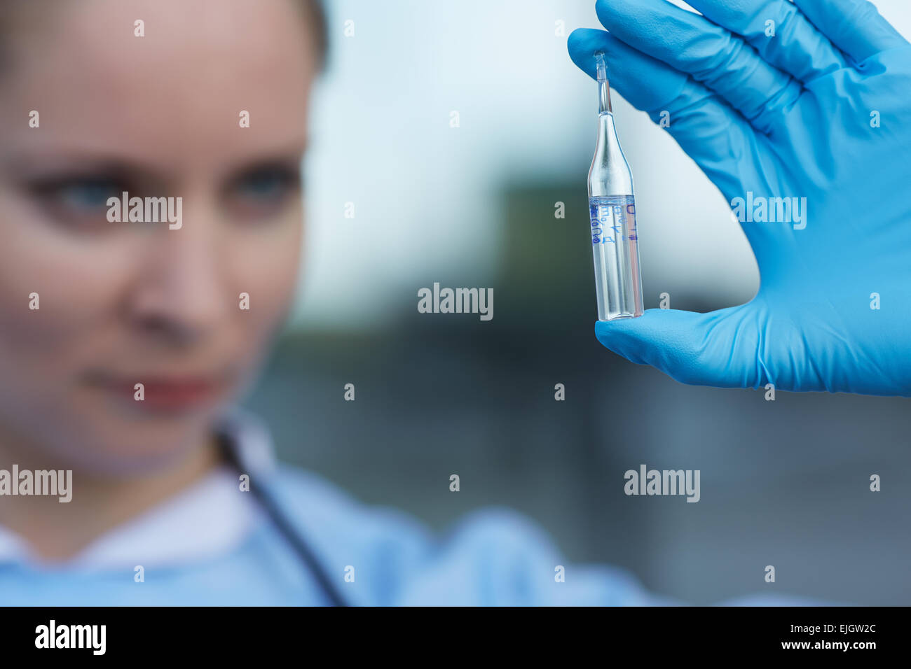 female doctor holding a vial Stock Photo - Alamy