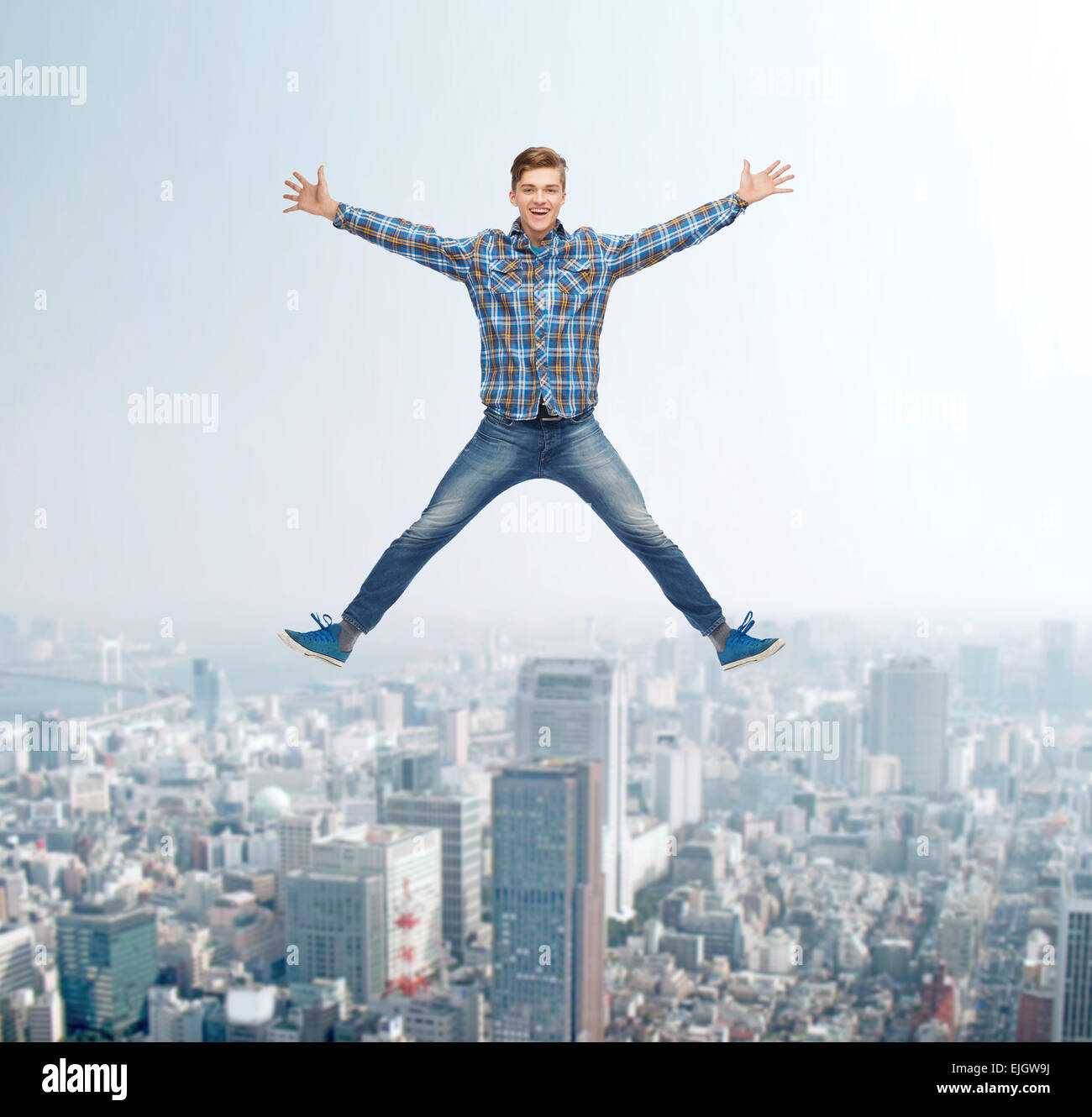 smiling young man jumping in air Stock Photo - Alamy