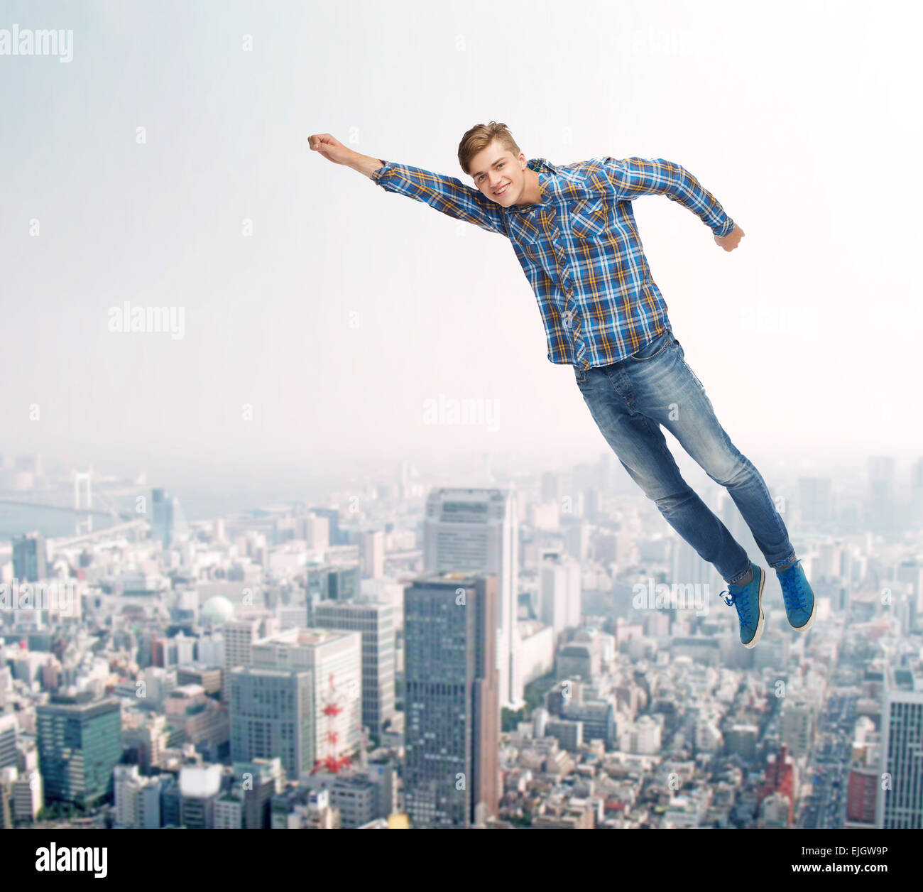 smiling young man jumping in air Stock Photo - Alamy