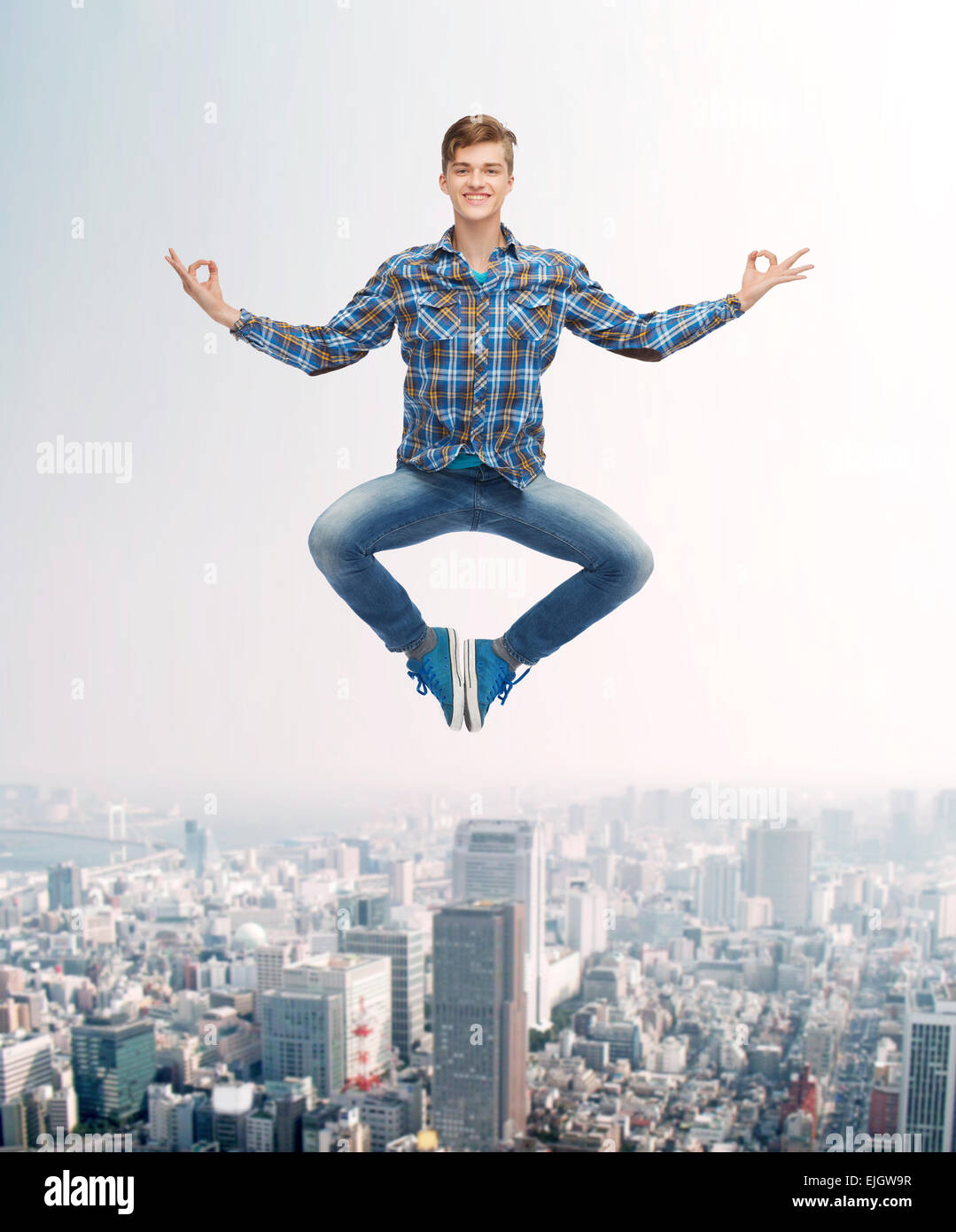 smiling young man jumping in air Stock Photo - Alamy