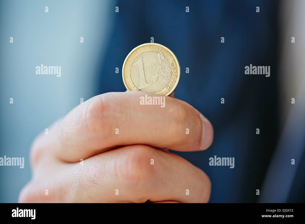 hand with euro coin Stock Photo - Alamy
