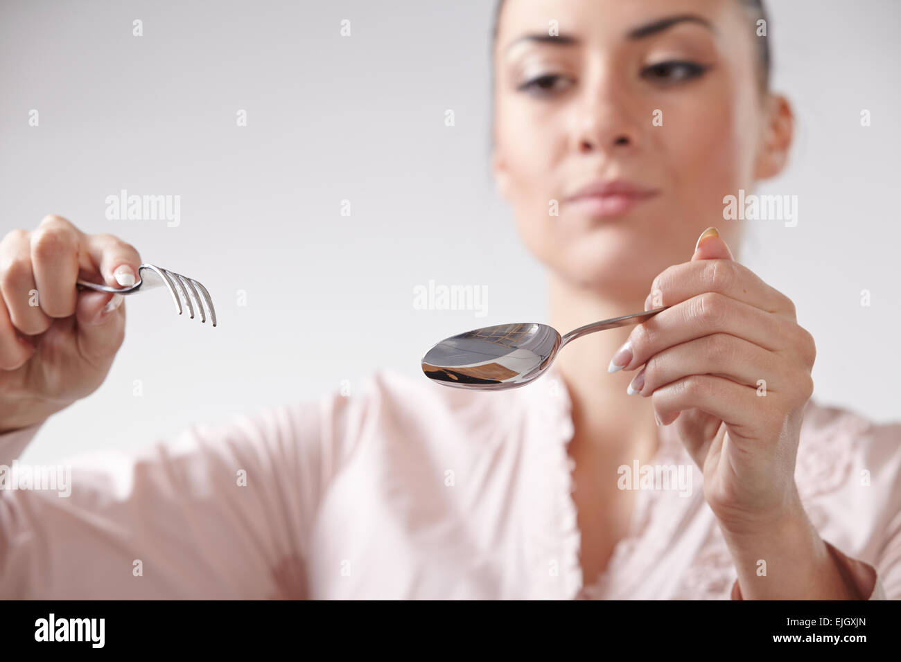 woman with spoon and fork Stock Photo - Alamy
