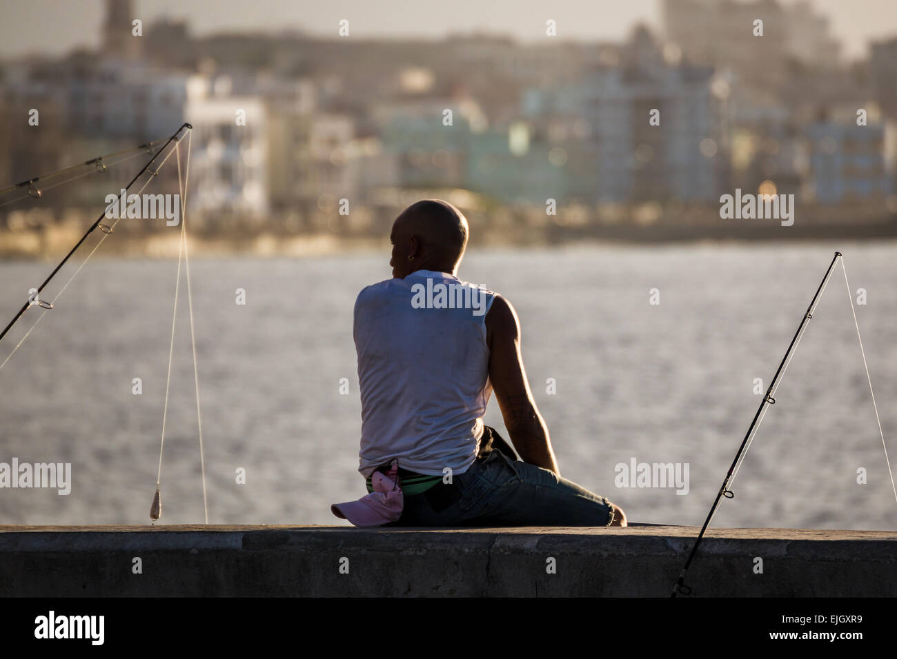 Local man fishing from the Malecon Stock Photo - Alamy