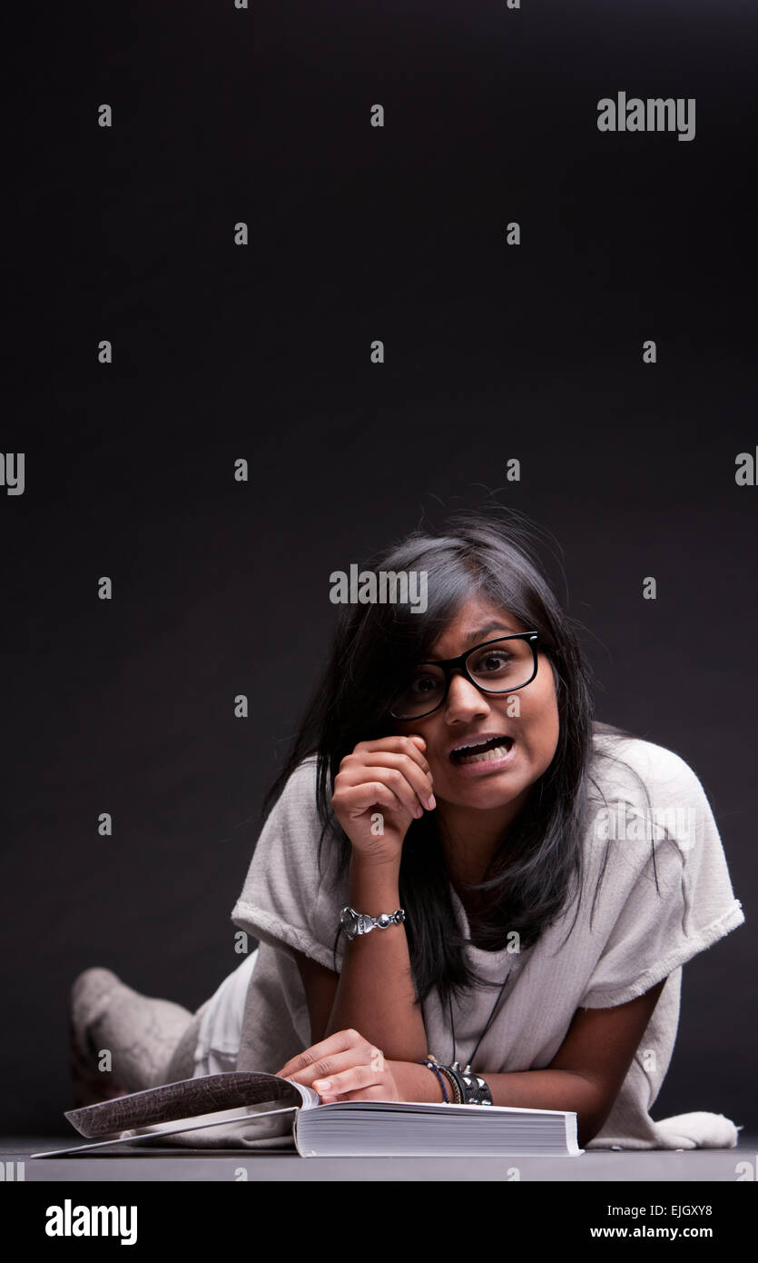 indian intelligent girl speaking of a book she read Stock Photo - Alamy