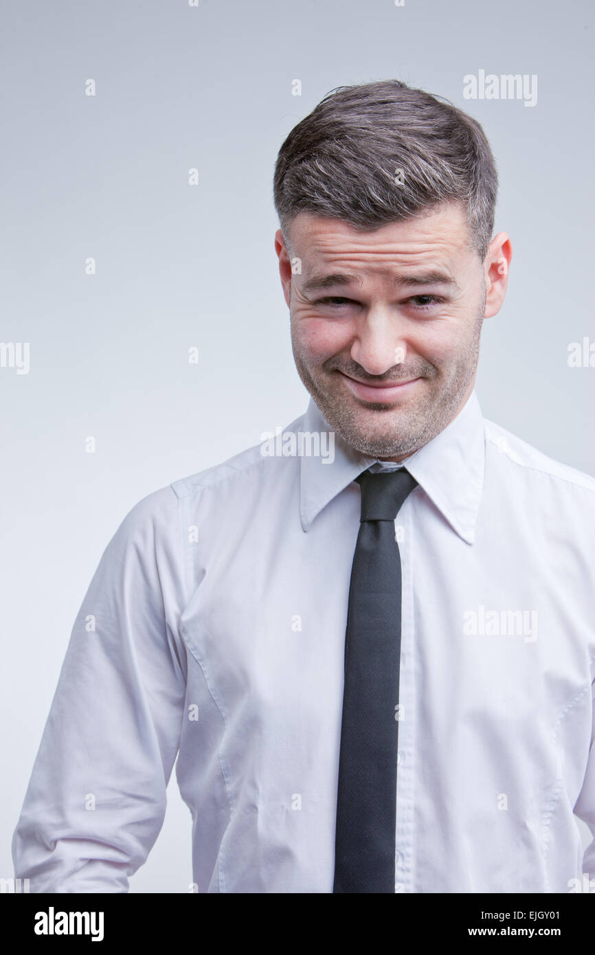 doubtful man laughing at you struggling to quit smiling Stock Photo - Alamy