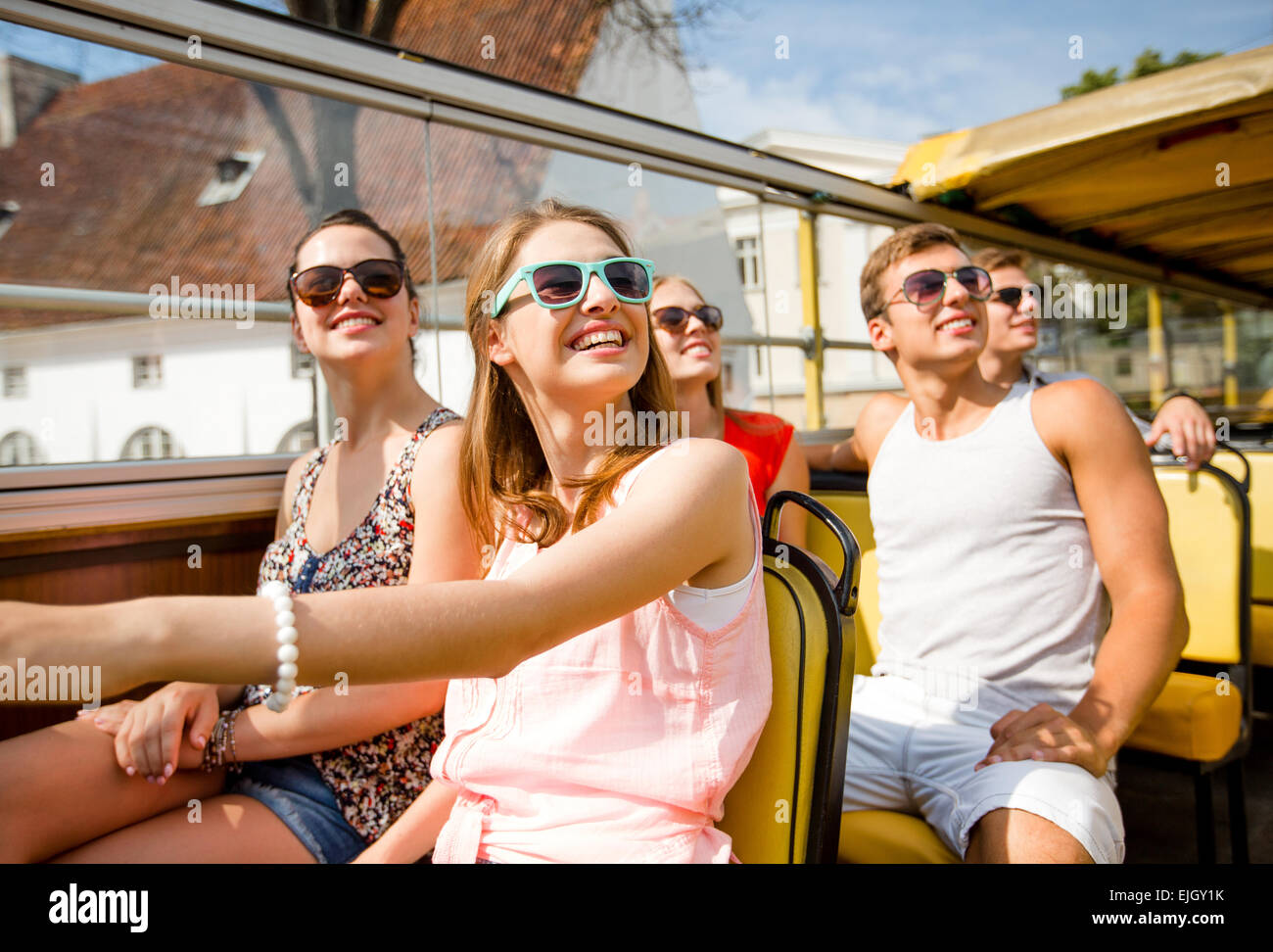 group of smiling friends traveling by tour bus Stock Photo - Alamy