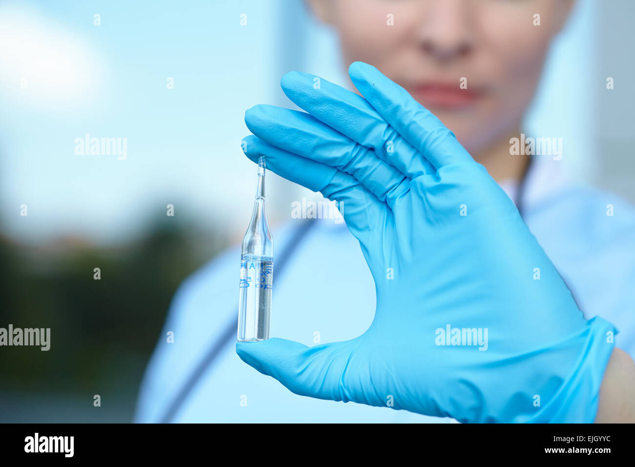 female doctor holding a vial Stock Photo - Alamy