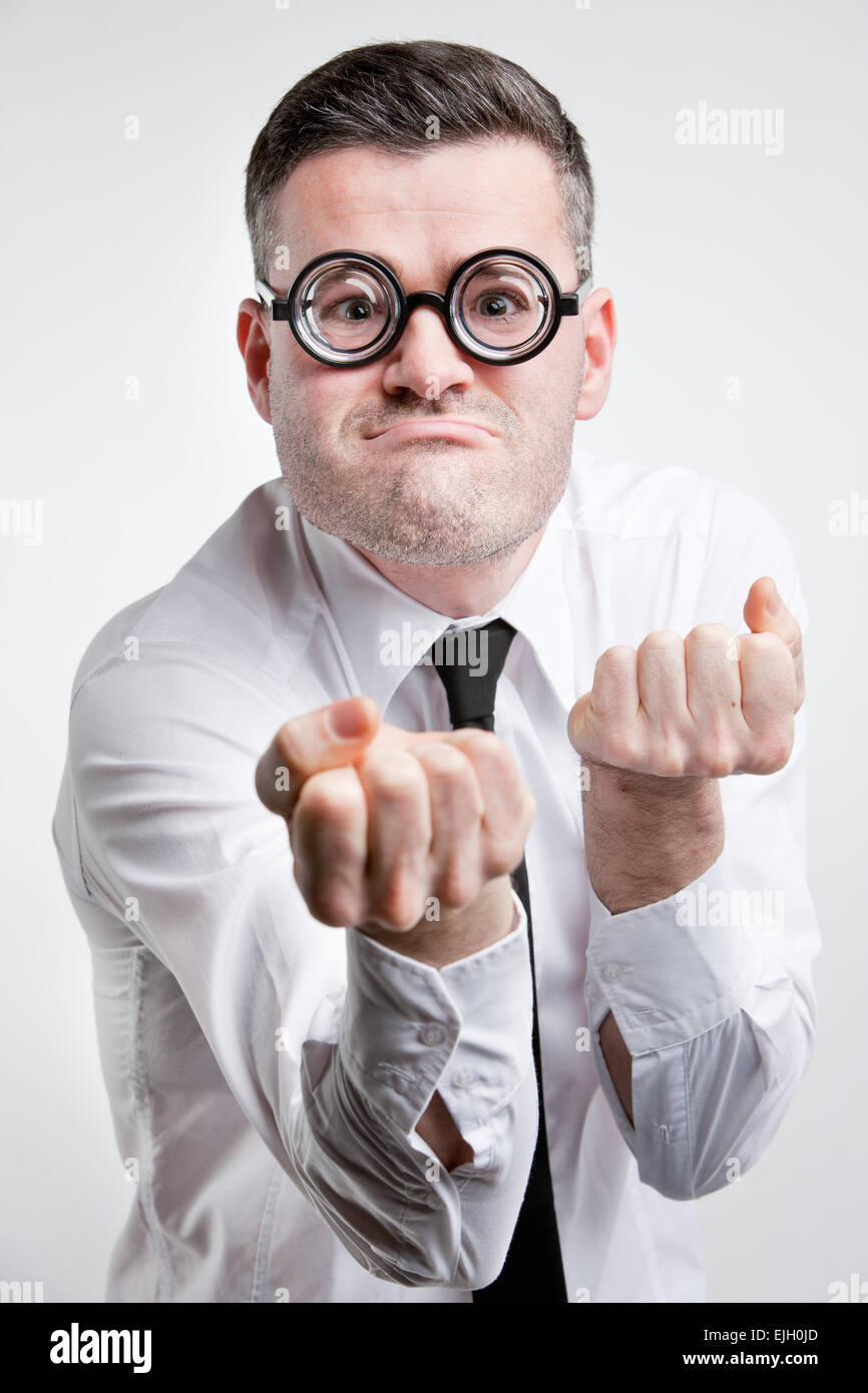 a nerdy office worker with a thick pair of glasses trying to menace you ...