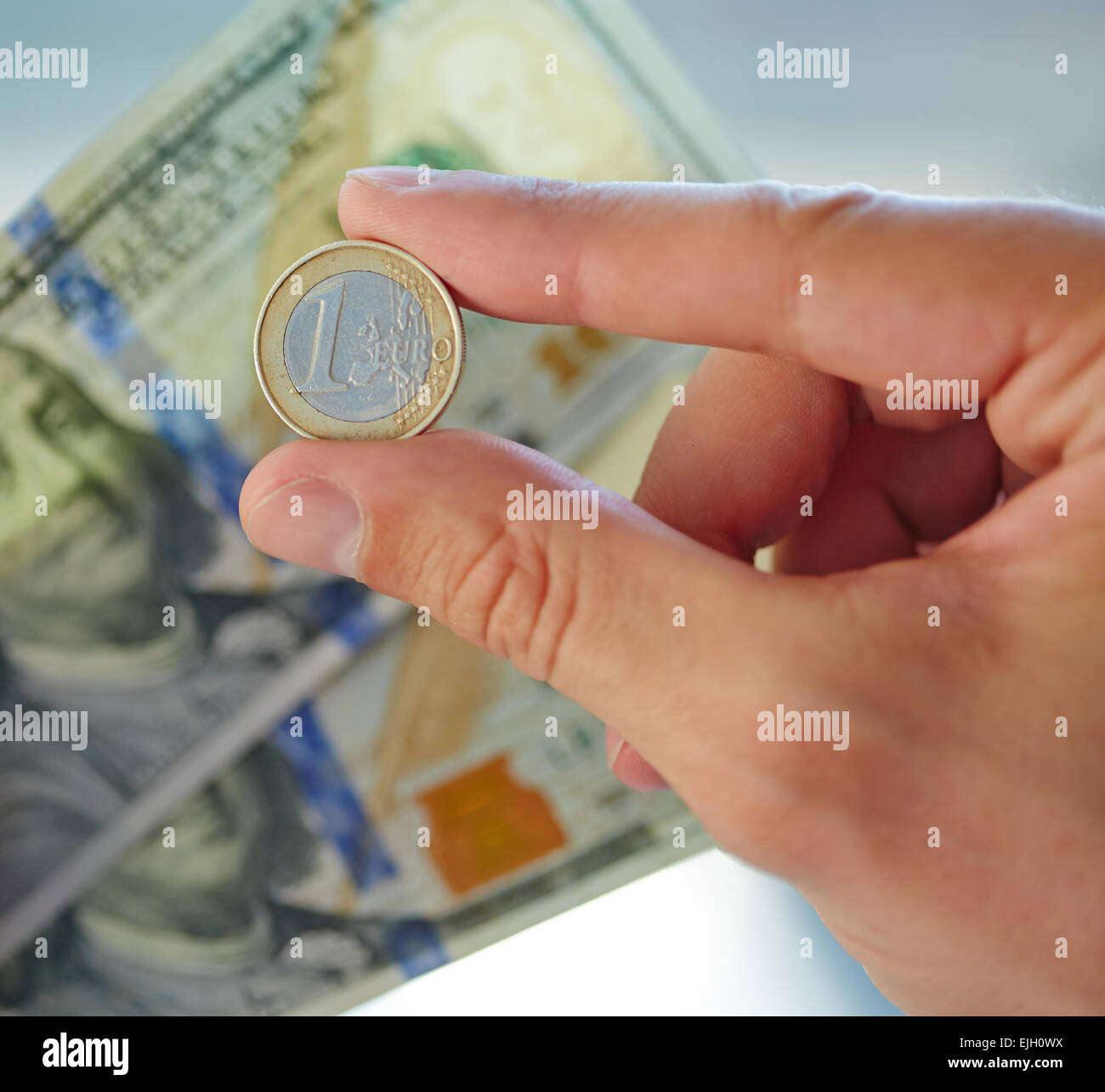 hand with dollars and euro coin Stock Photo - Alamy