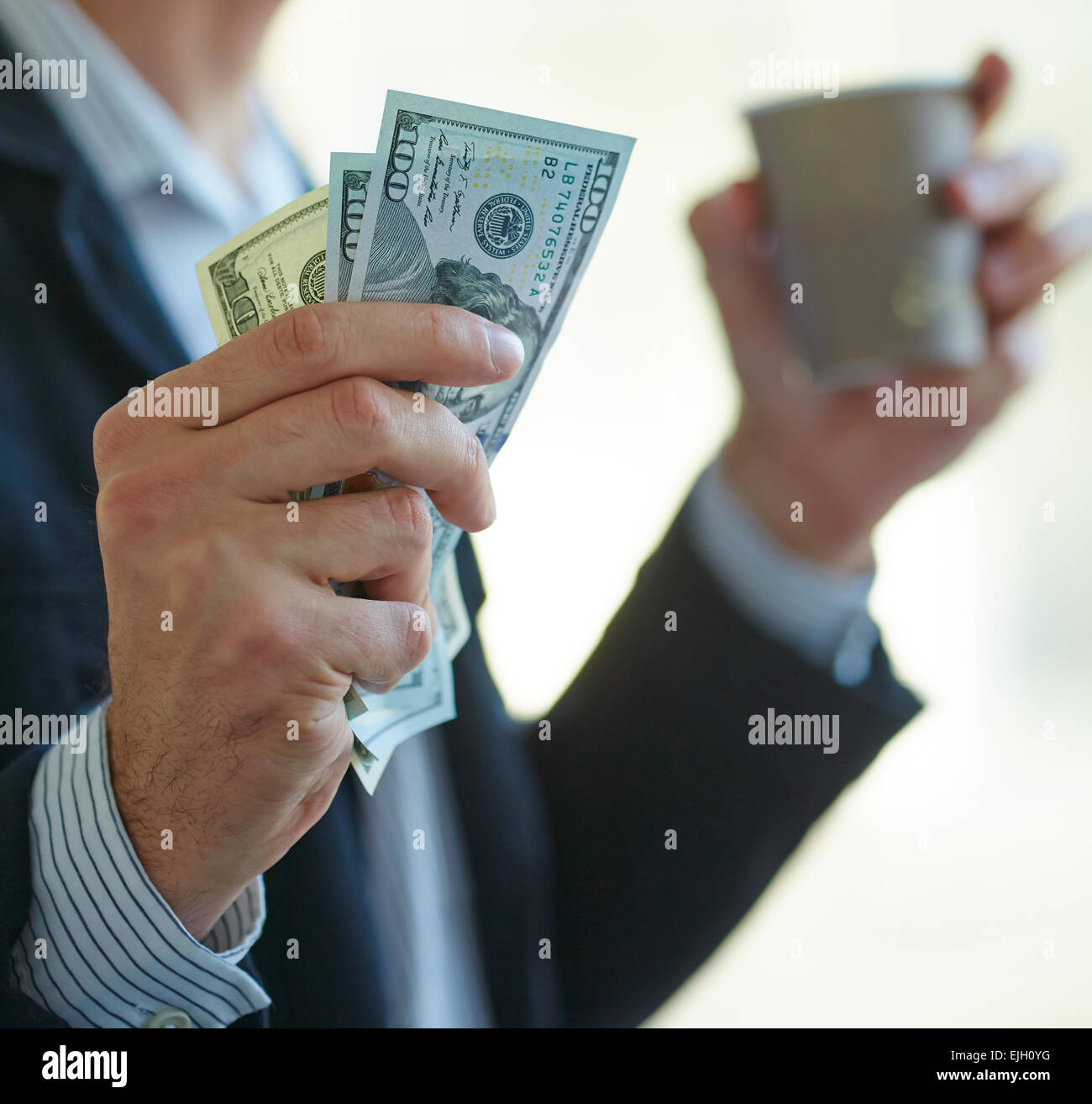 Businessman holding money in his hands Stock Photo - Alamy