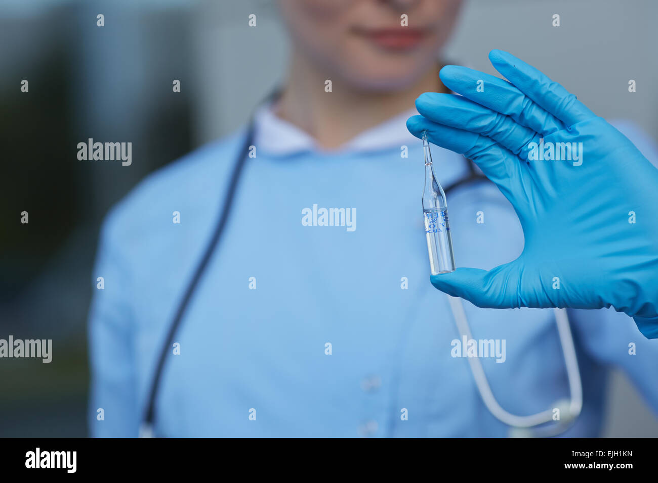 female doctor holding a vial Stock Photo - Alamy