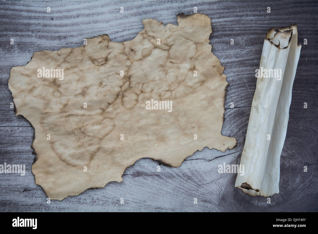 Piece of old paper and old paper roll on wooden background Stock Photo ...