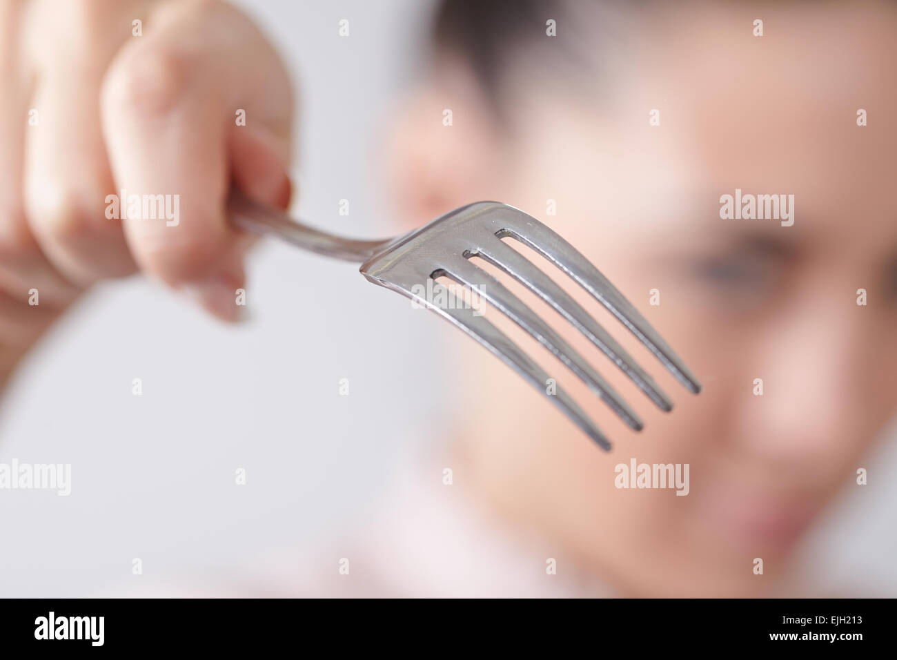 woman with spoon and fork Stock Photo - Alamy