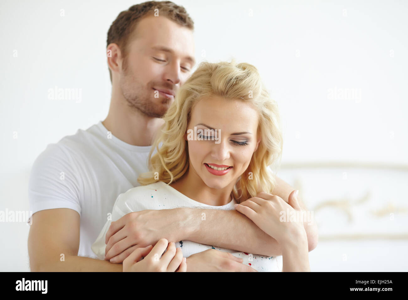 couple standing embracing Stock Photo - Alamy