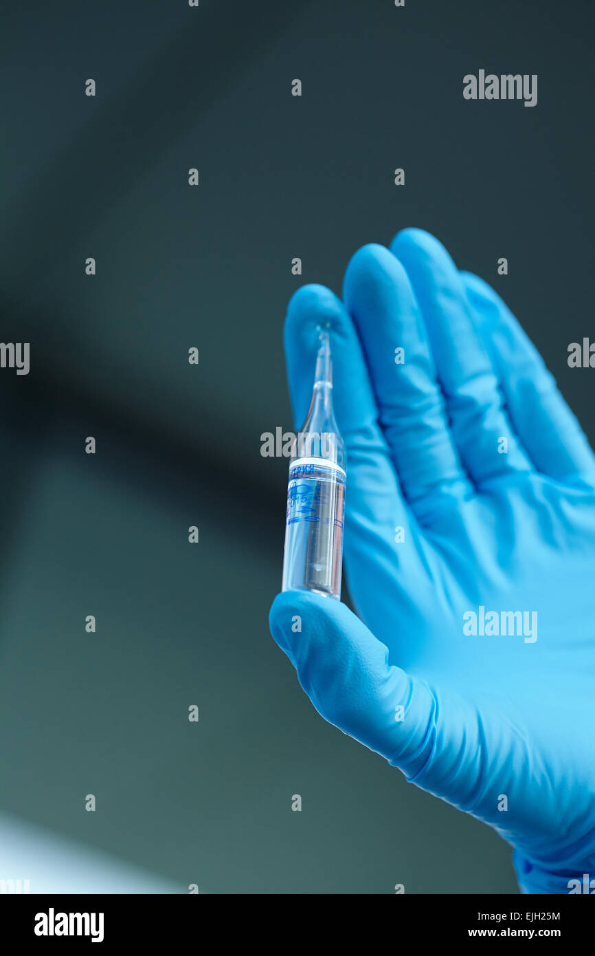 female doctor holding a vial Stock Photo - Alamy
