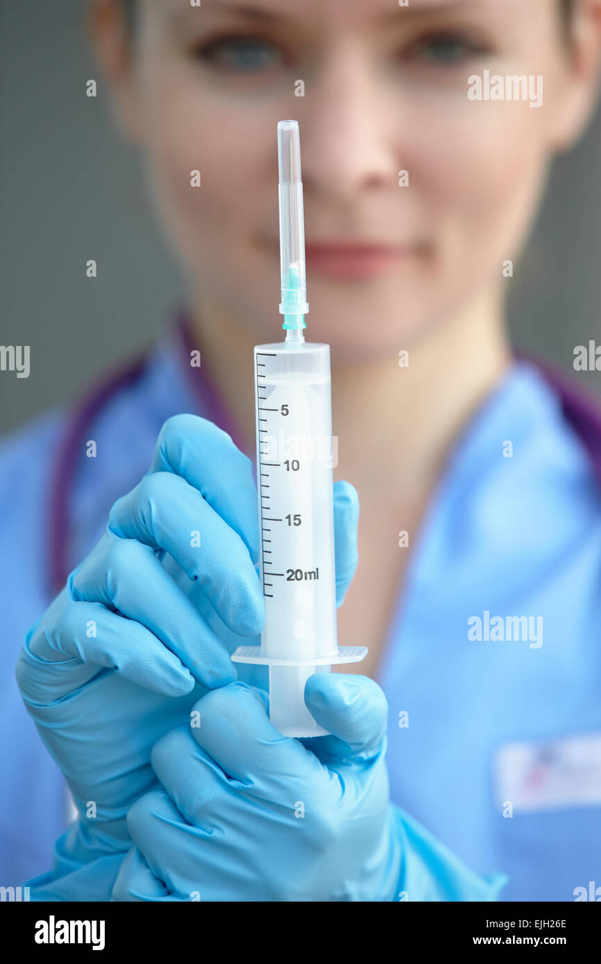 female doctor holding a syringe Stock Photo - Alamy
