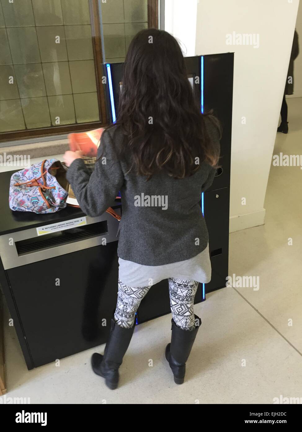 Checking out a book hi-res stock photography and images - Alamy