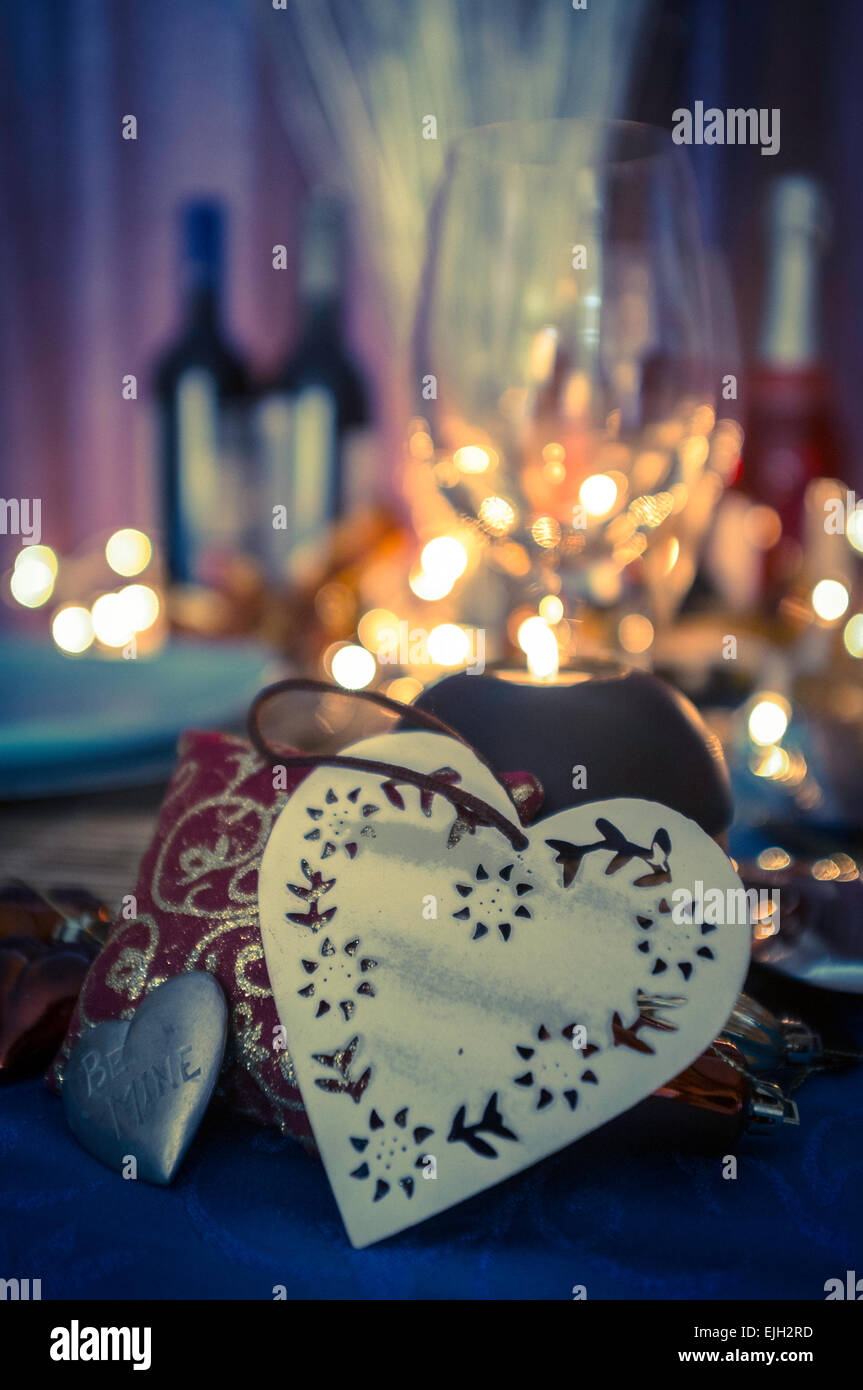 heart shaped trinket among table setting and decorations for romantic ...