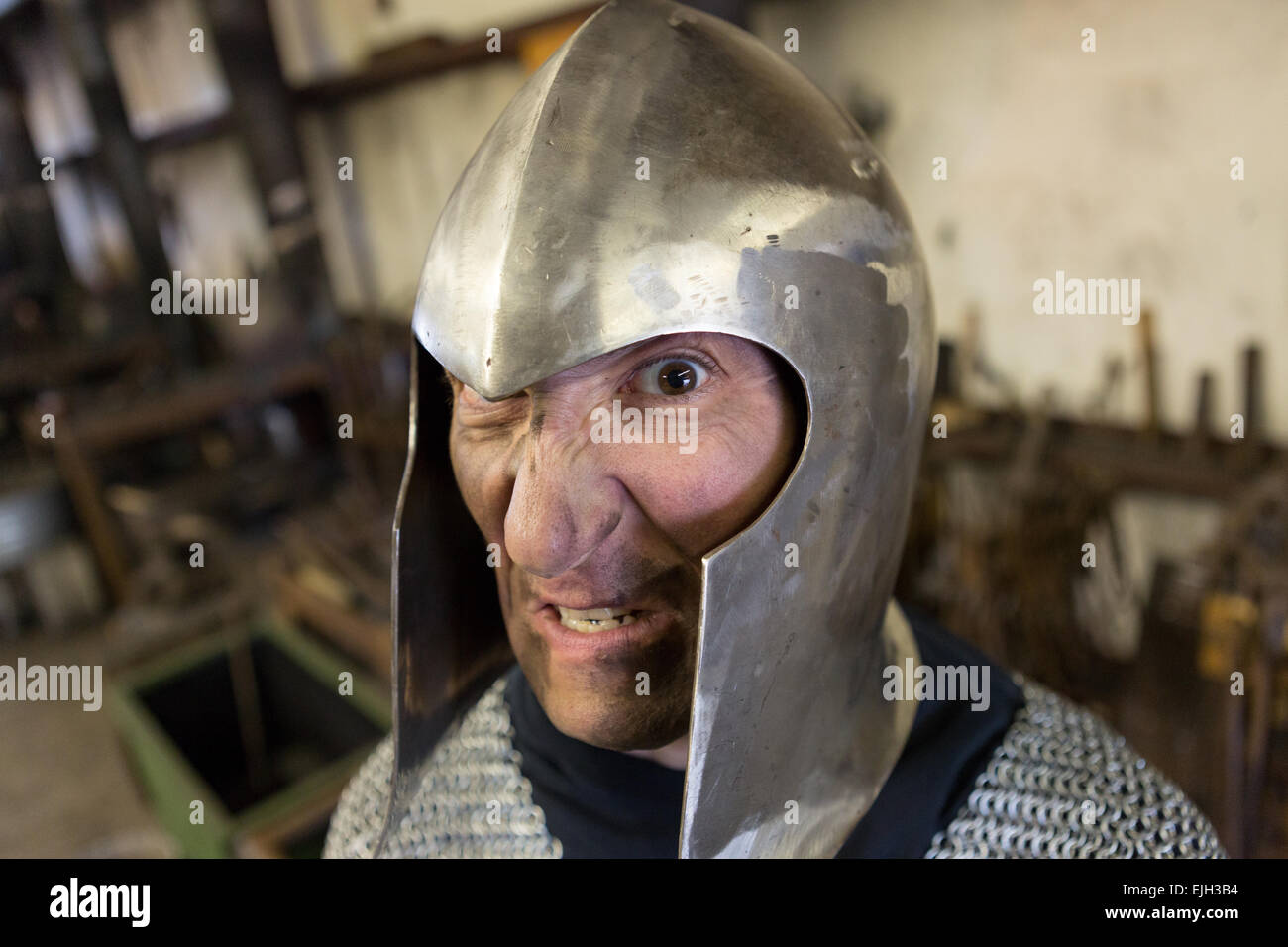 Blacksmith Frank Verga wearing a medieval helmet he made in his metal ...