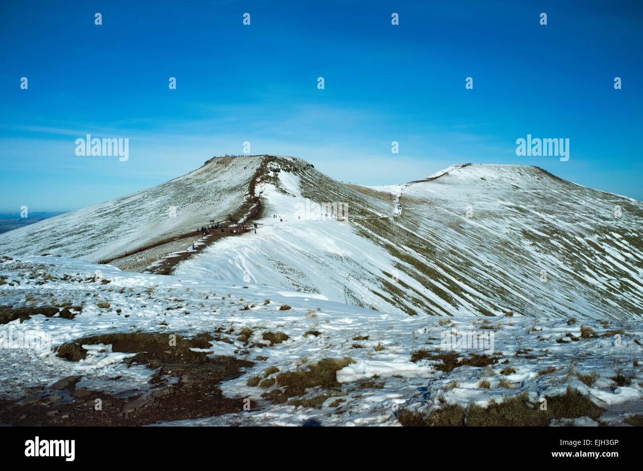 Partially snow covered mountain slopes in Brecon Beacons National Park ...
