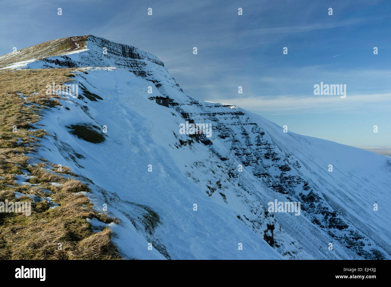 Partially snow covered mountain slopes in Brecon Beacons National Park ...