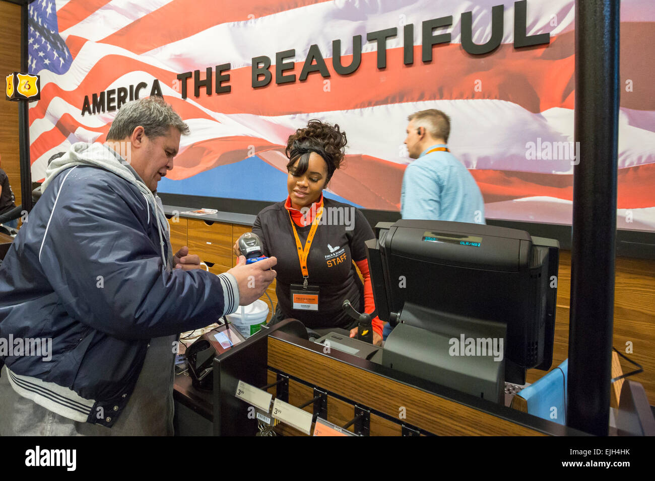 Troy, Michigan - A checkout clerk at the Field & Steam outdoors store ...