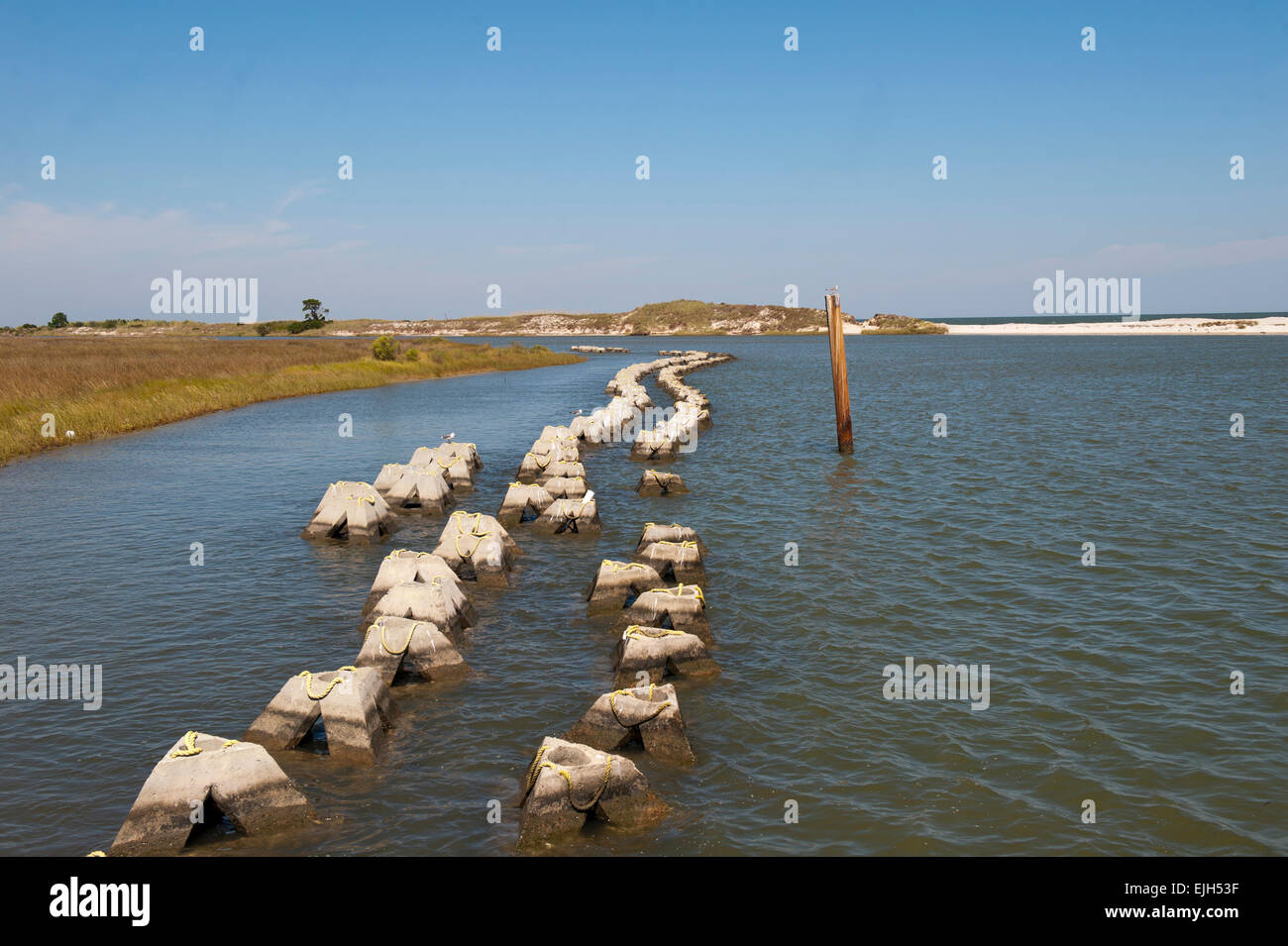 Concrete jetty along the shoreline on Dauphin Island Alabama Stock ...
