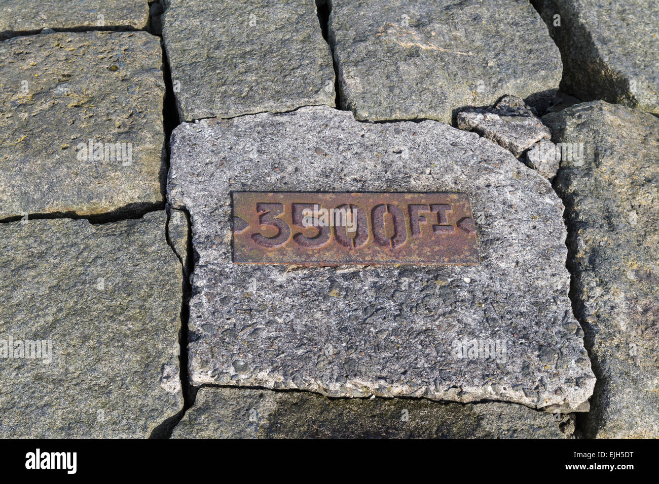 Marker plate on breakwater Stock Photo - Alamy