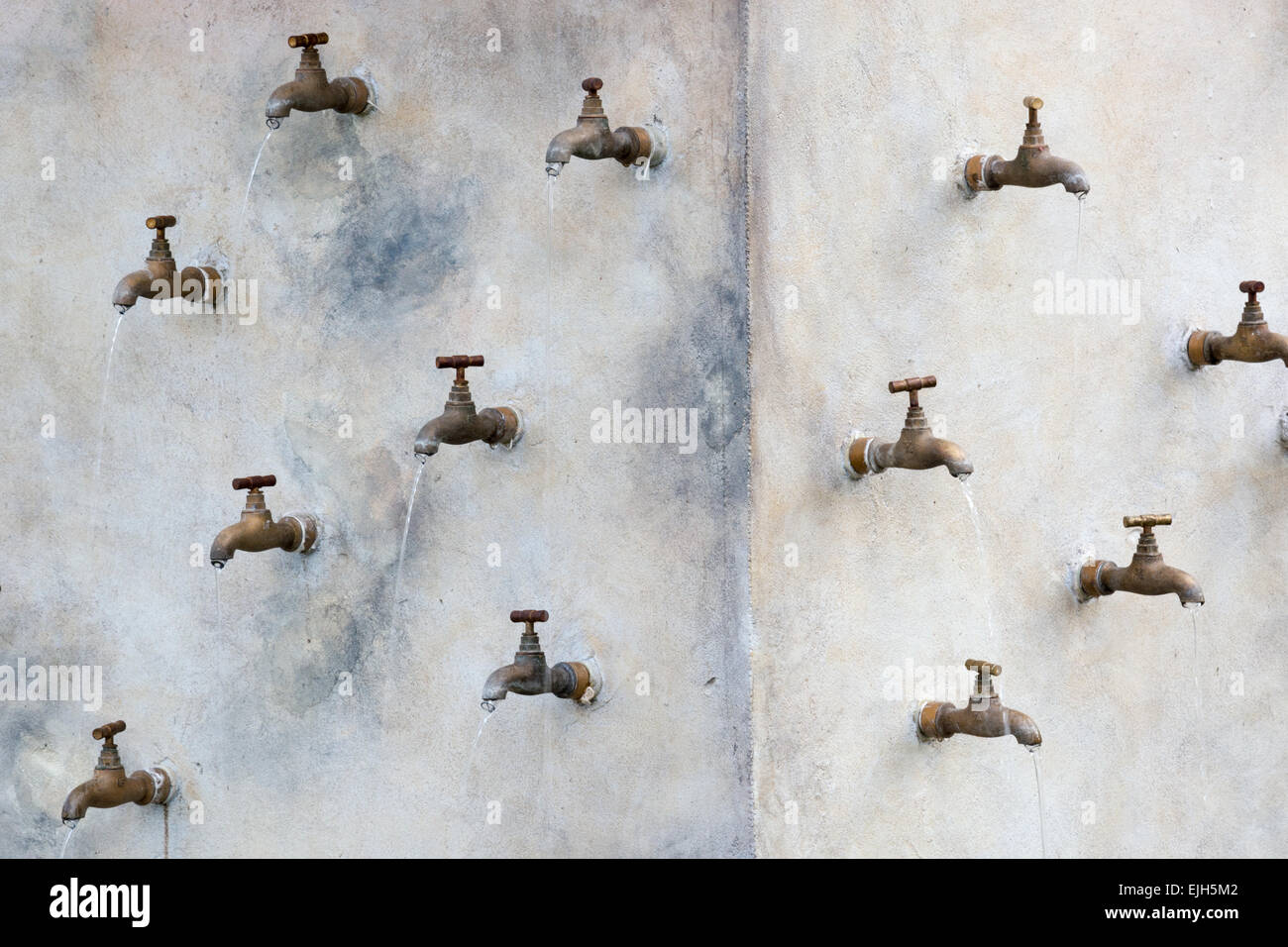 Group of water taps mounted on the wall Stock Photo - Alamy