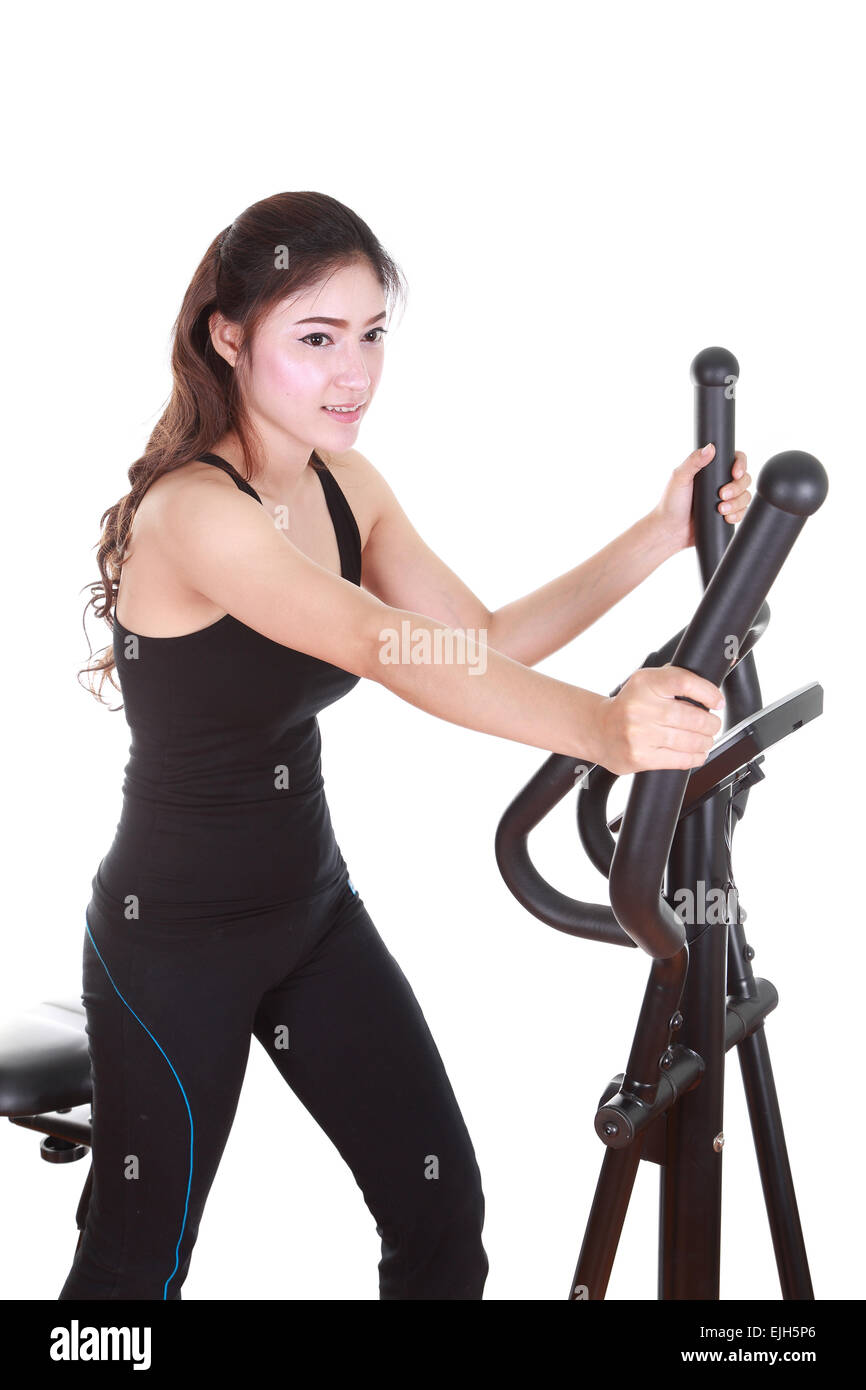 young woman doing exercises with exercise machine, on white background ...
