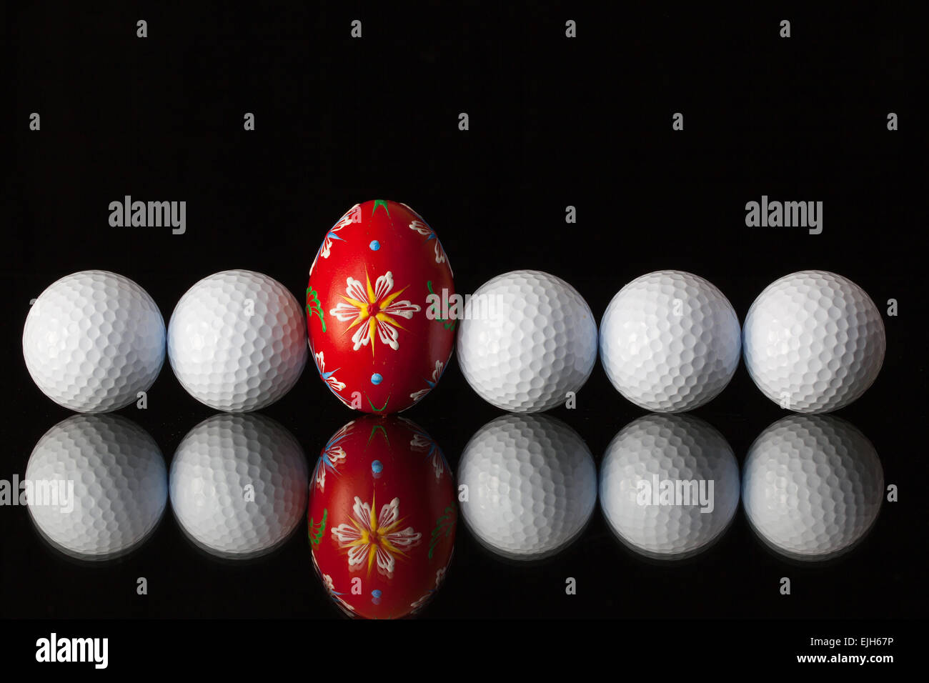 Golf equipments and egg on a black glass desk Stock Photo - Alamy