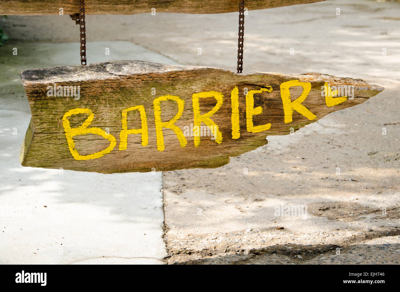 Old wooden warning sign as a barrier, hooked on the chain Stock Photo ...