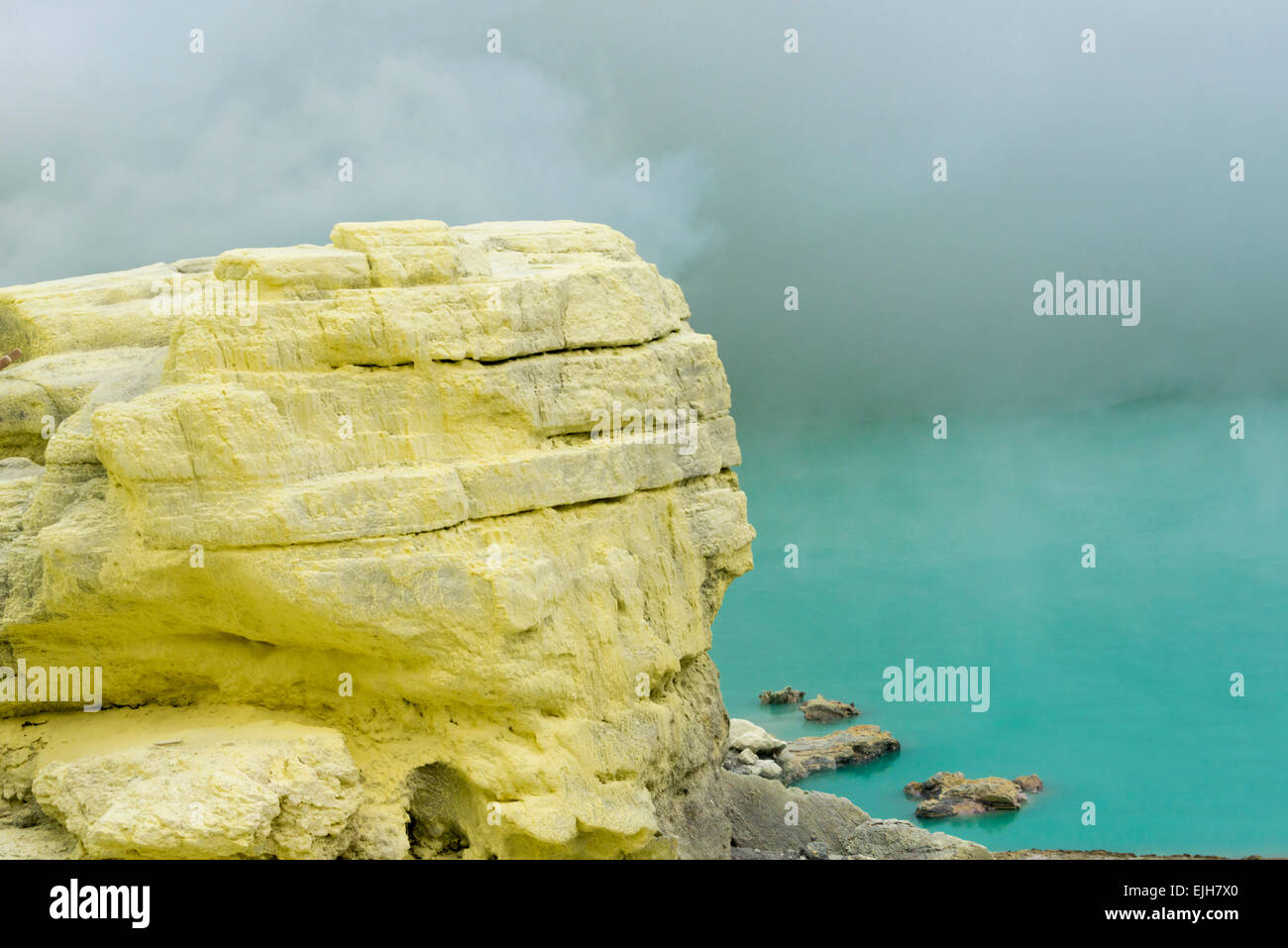 Sulfur rock by lake in Ijen volcano, East Java, Indonesia Stock Photo ...