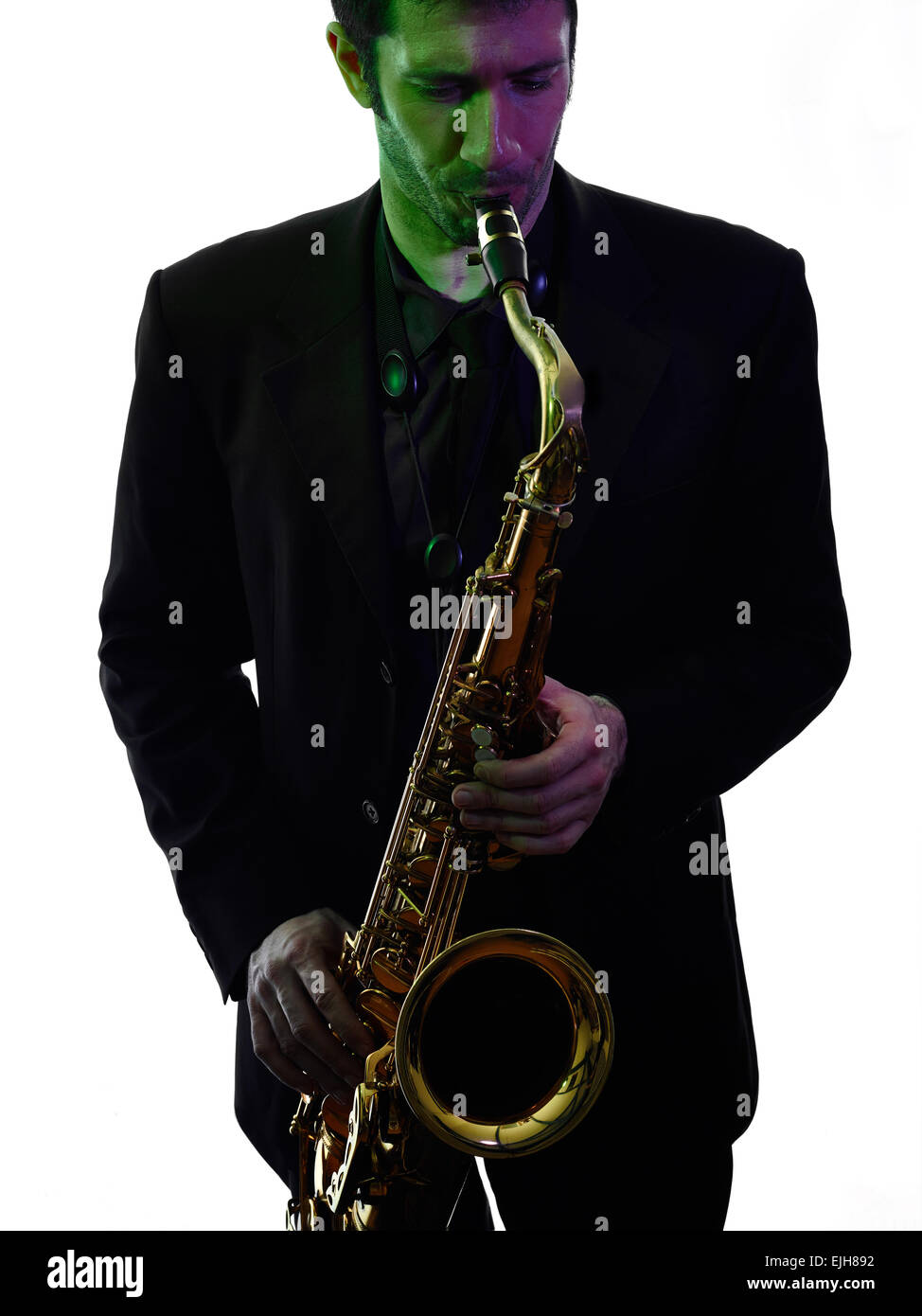 one caucasian man saxophonist playing saxophone player in studio ...