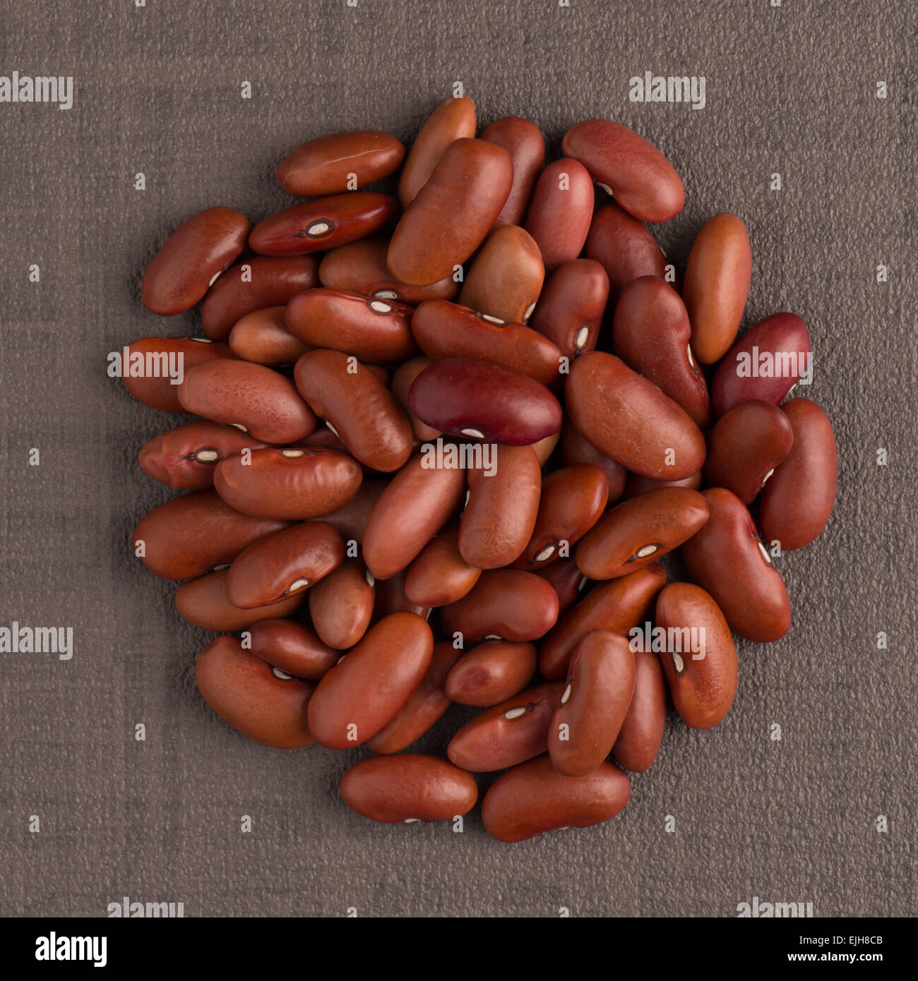 Circle of red beans on brown vinyl background Stock Photo - Alamy