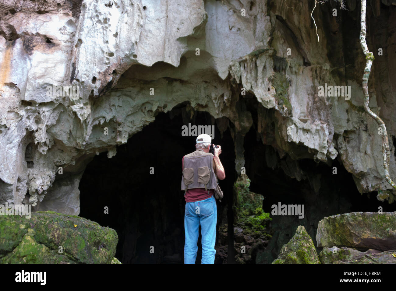 Tourist photographing Kontilola Cave, Baliem Valley, Wamena, Papua ...