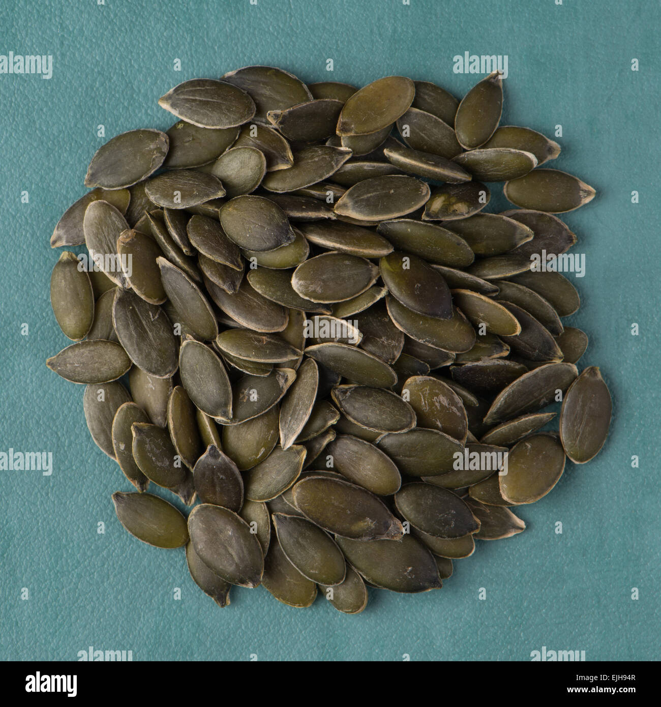 Top view of circle of pumpkin seeds against blue vinyl background Stock ...
