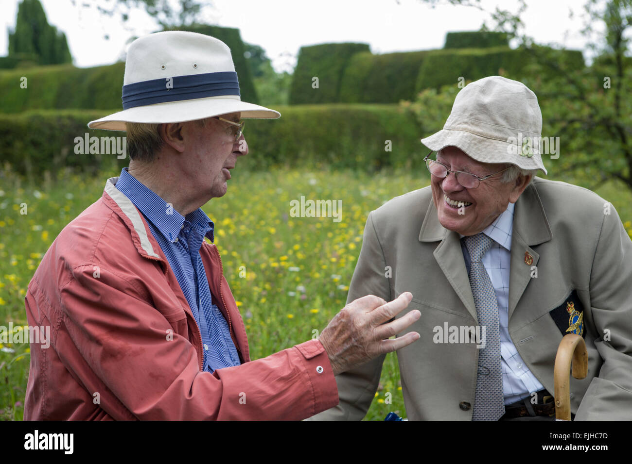 Two men in conversation outside Great Dixter House in Kent, England ...