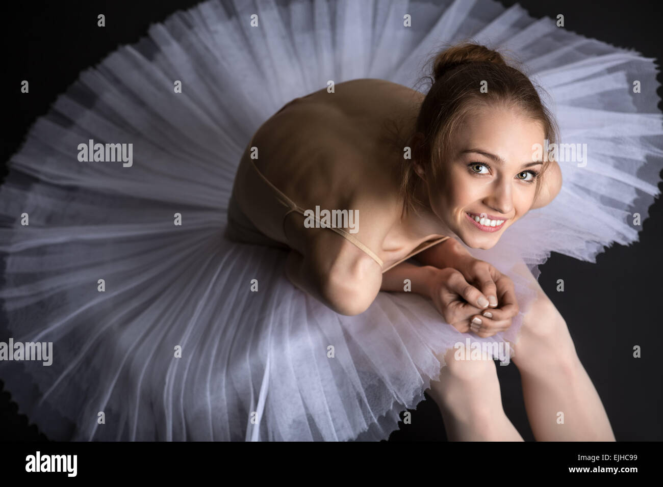 Graceful ballerina sitting on the floor Stock Photo - Alamy