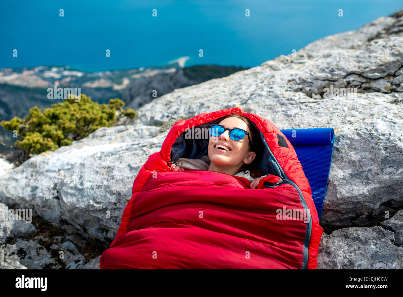 Woman in sleeping bag on the mountain Stock Photo - Alamy