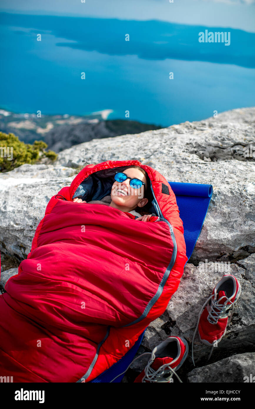 Woman in sleeping bag on the mountain Stock Photo - Alamy