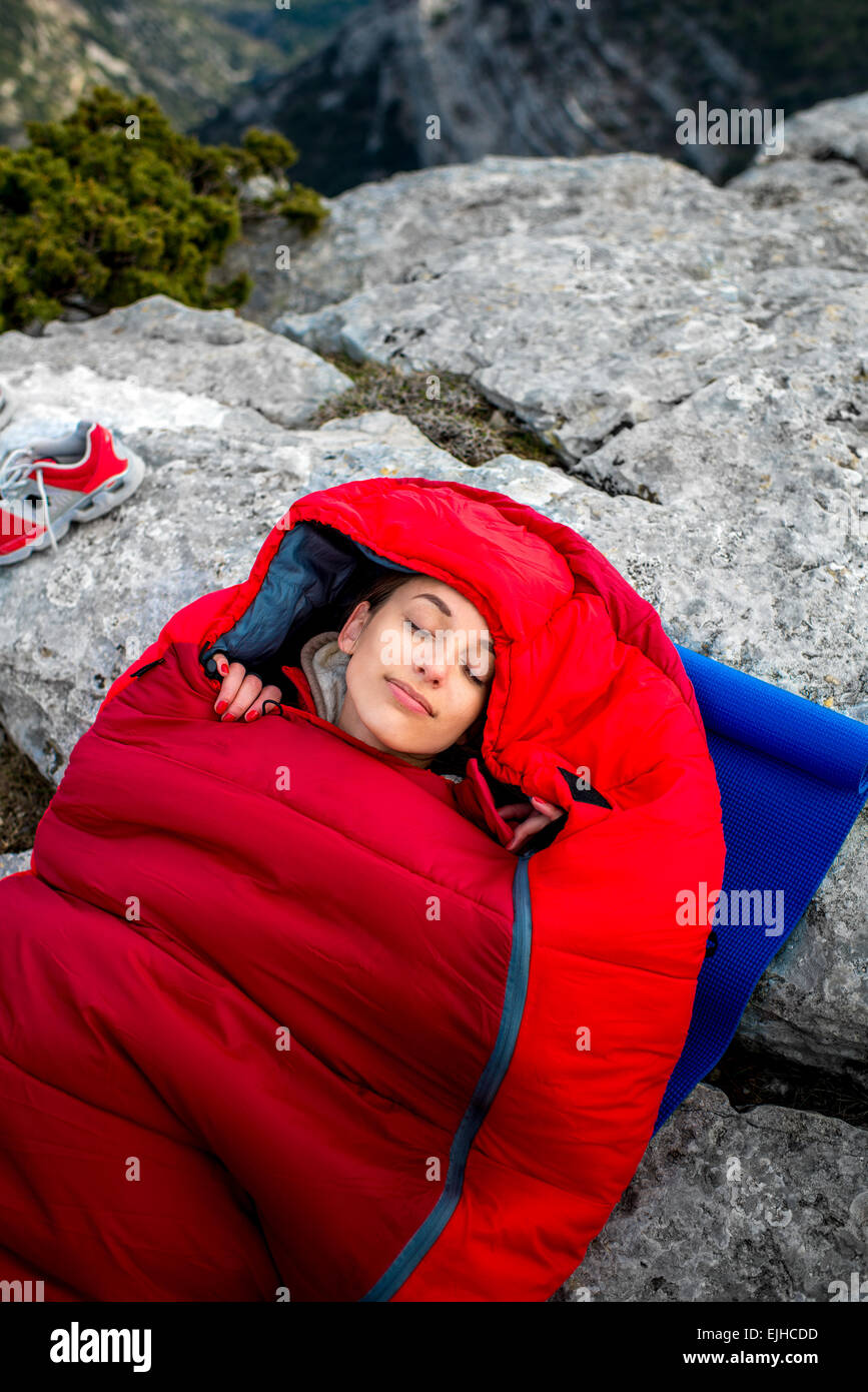 Woman in sleeping bag on the mountain Stock Photo - Alamy