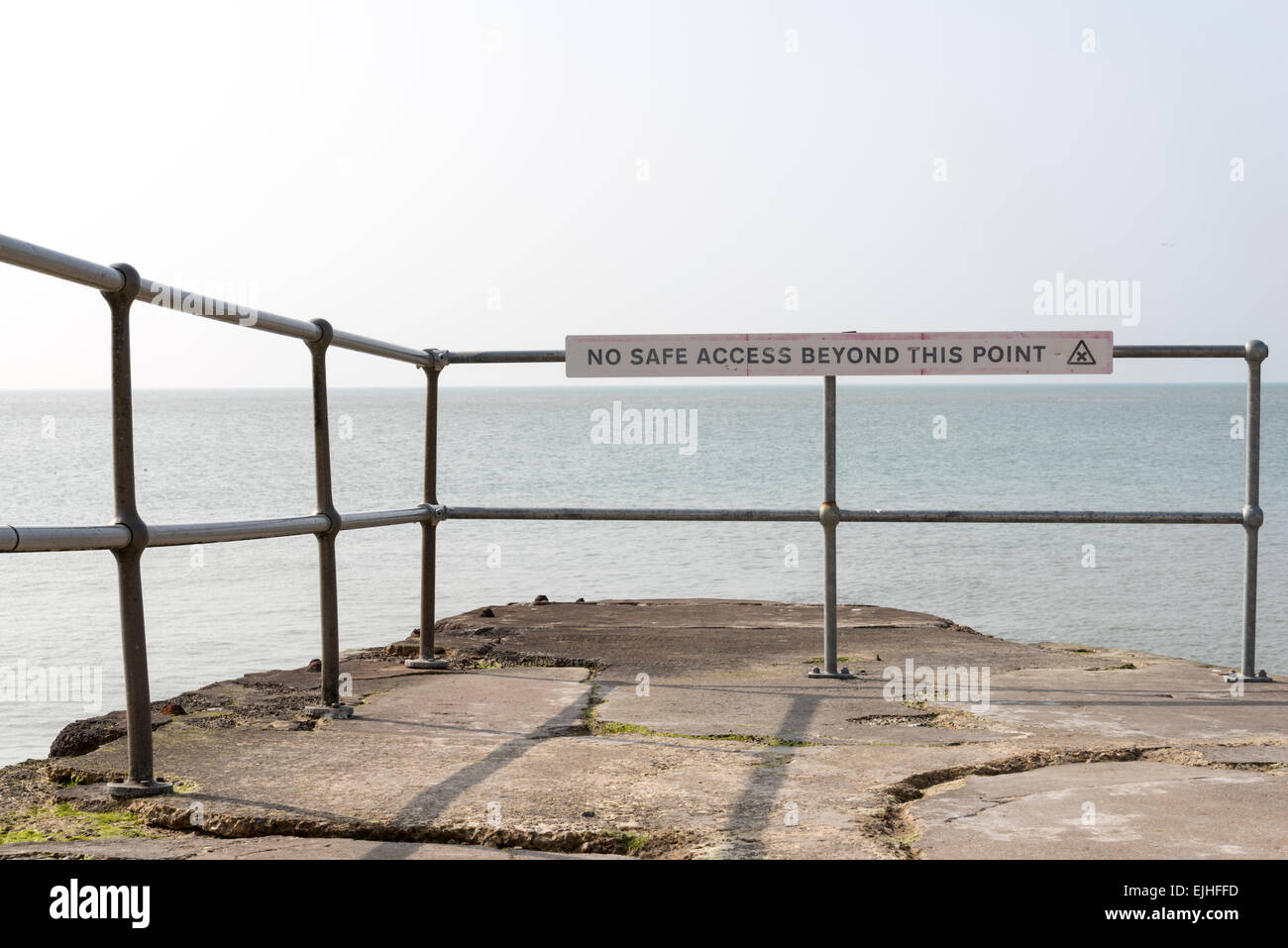 A concrete pier and fence with warning notice at Splashpoint, Seaford ...