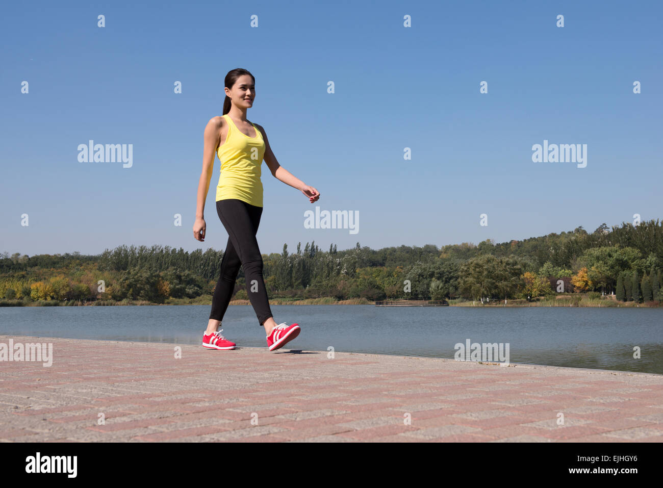 Woman walking smiling exercise park hi-res stock photography and images ...