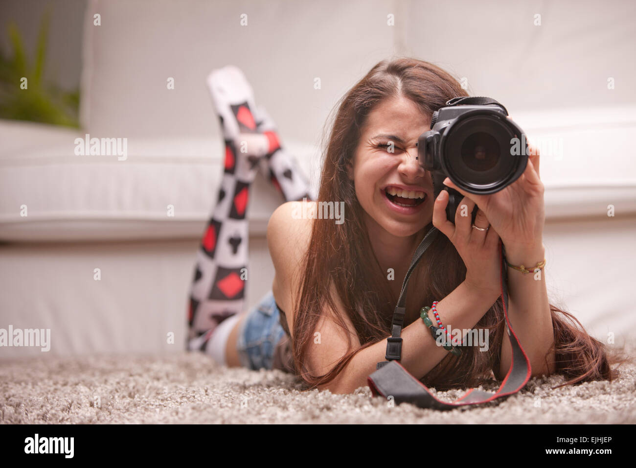 pretty girl taking photographs with a professional digital camera with ...