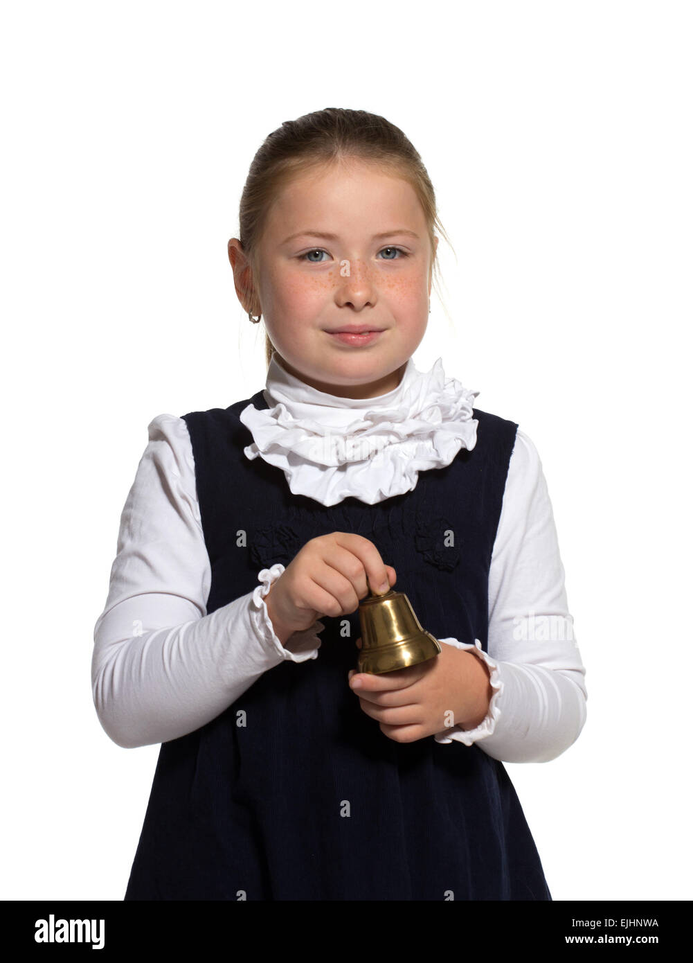 Young school girl ringing a golden bell on white background Stock Photo ...