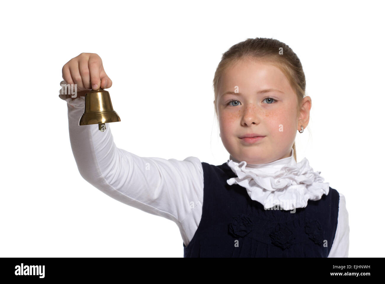 Young school girl ringing a golden bell on white background Stock Photo ...