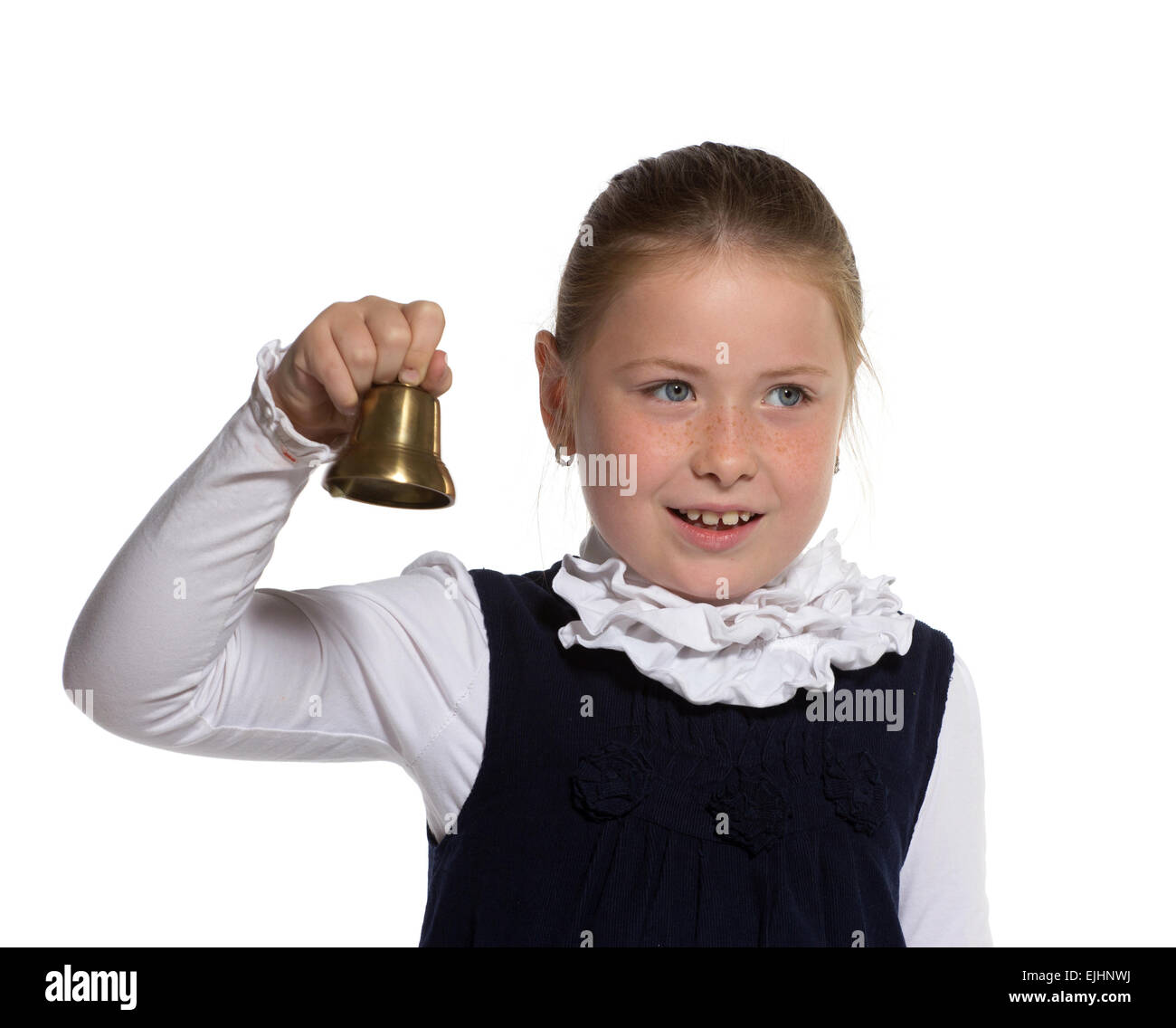 Young school girl ringing a golden bell on white background Stock Photo ...